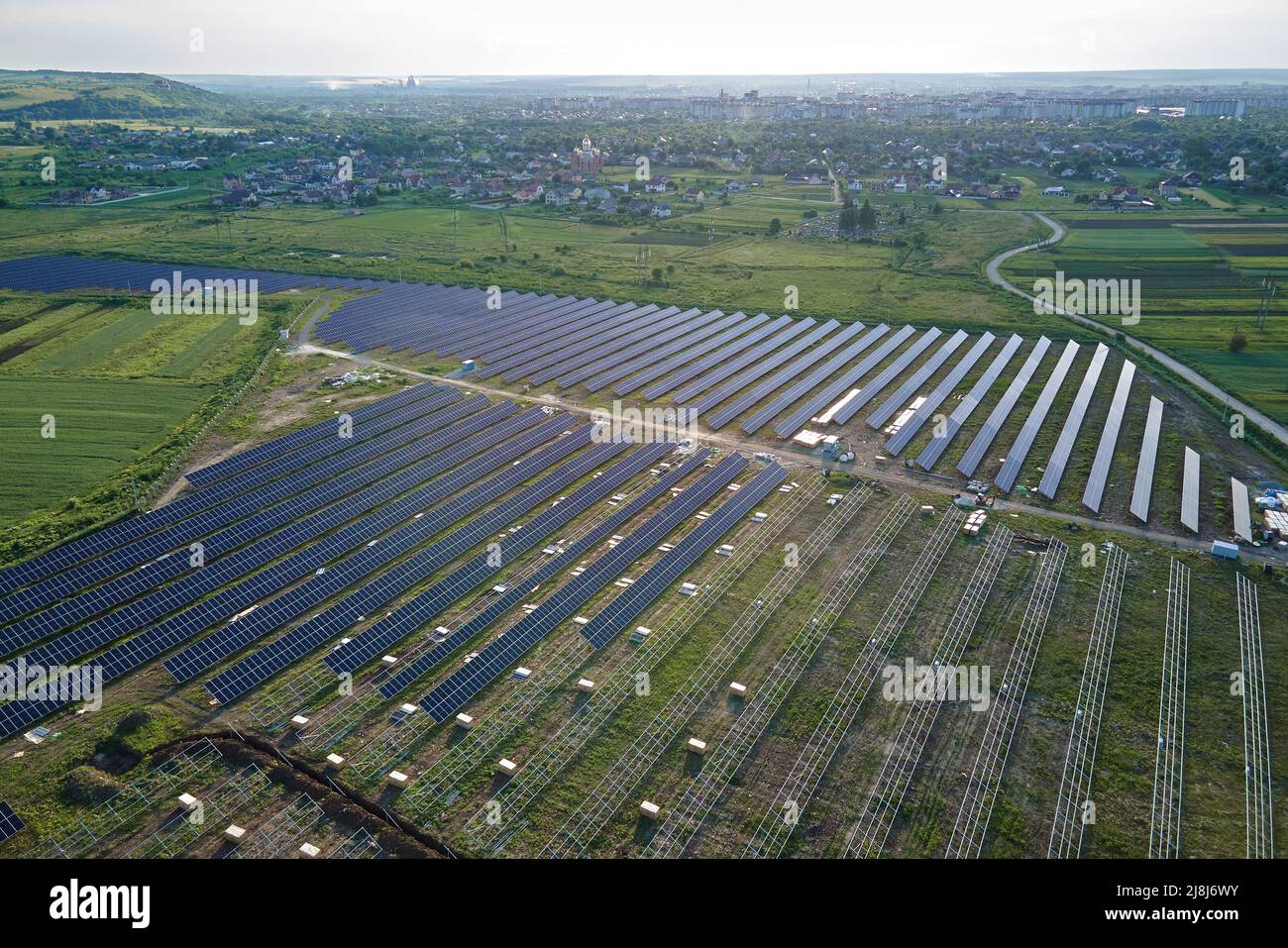 Aerial view of big electric power plant under construction with many ...