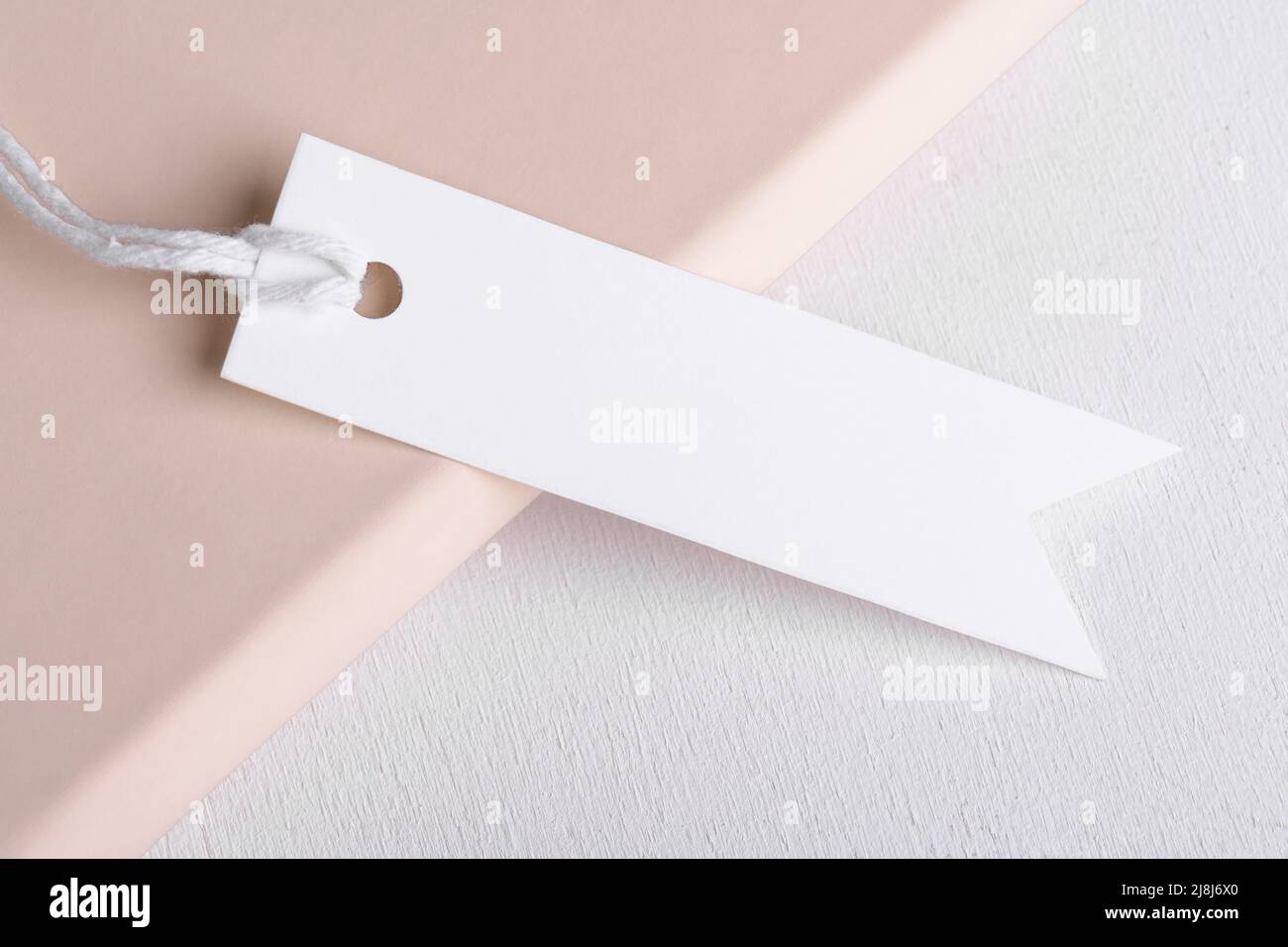 Rectangle strip white gift tag mockup with white cord, close up on ...