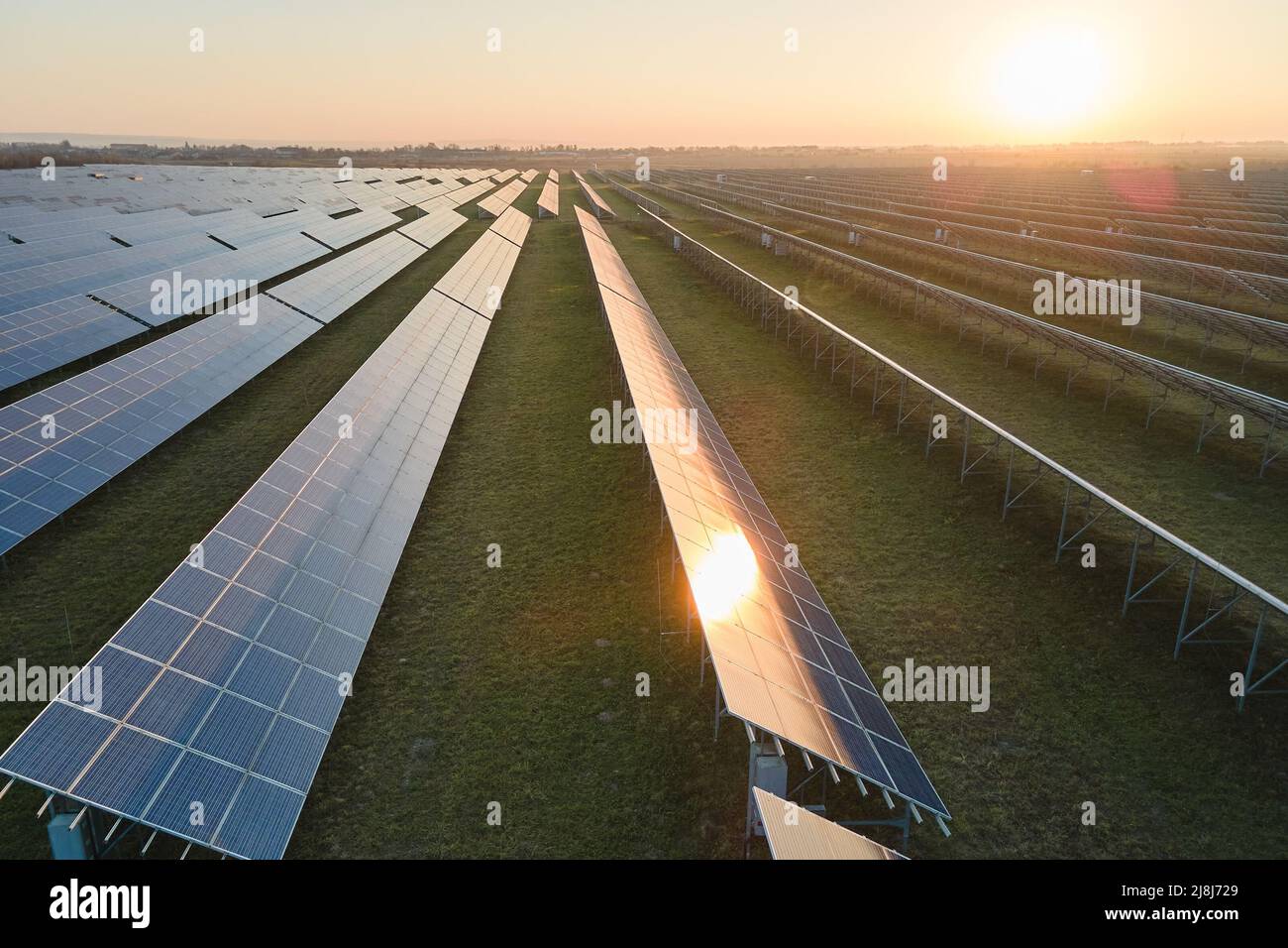 Aerial view of big sustainable electric power plant with many rows of ...