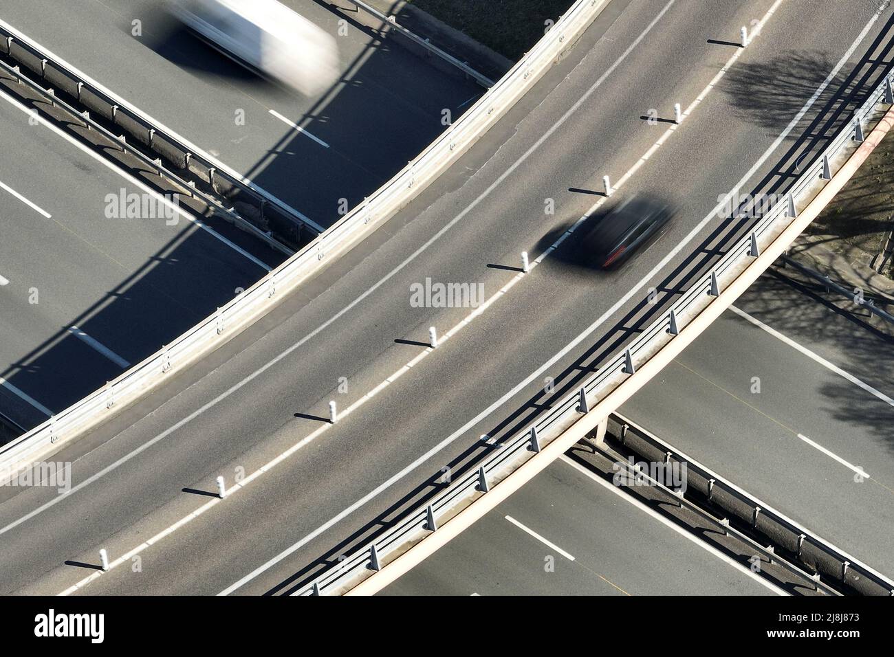 Aerial view of highway road intersection with fast moving heavy traffic ...