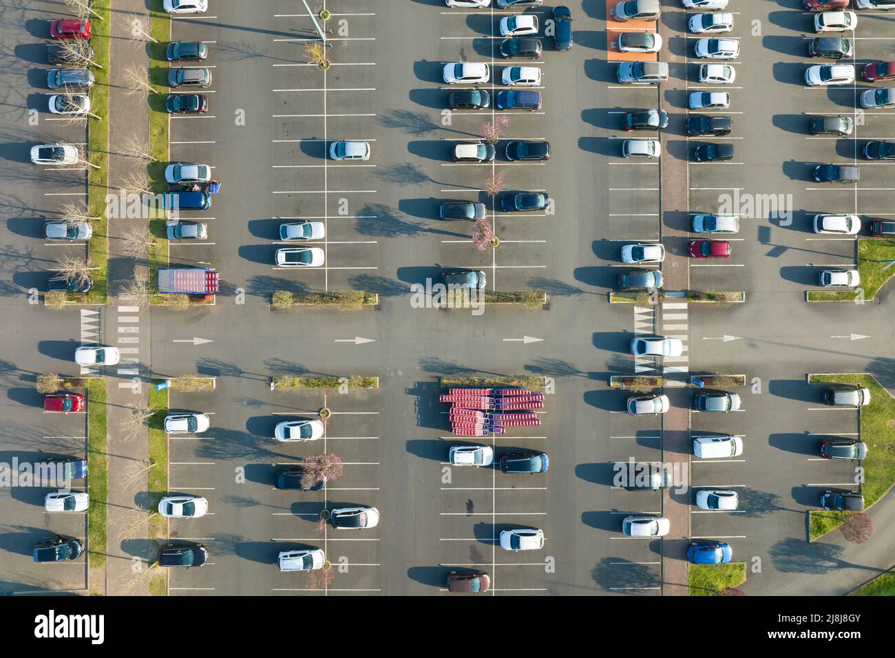 Aerial view of many colorful cars parked on parking lot with lines and ...