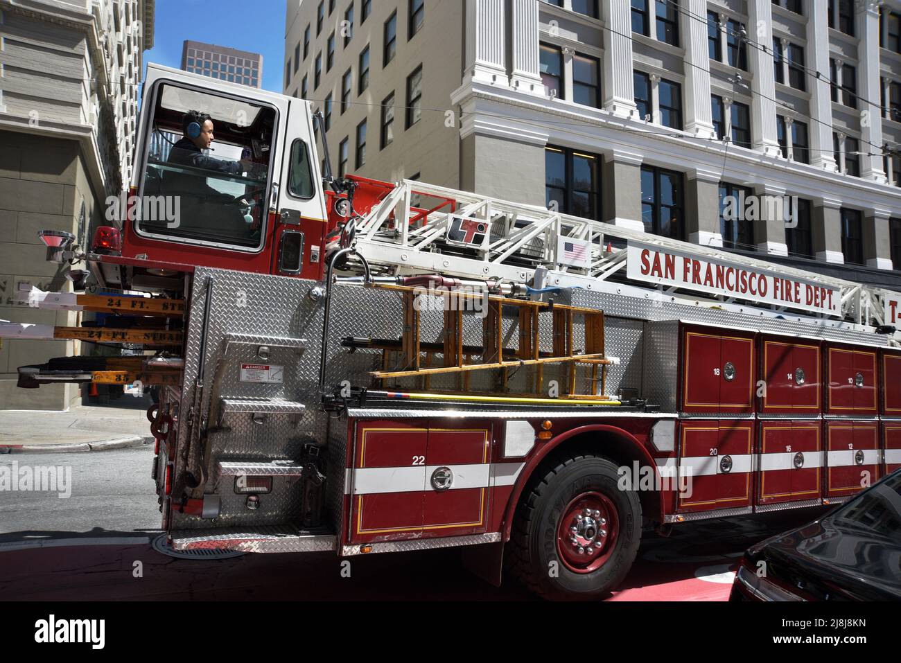 A tiller fire truck with steering wheels both the front and back moves ...