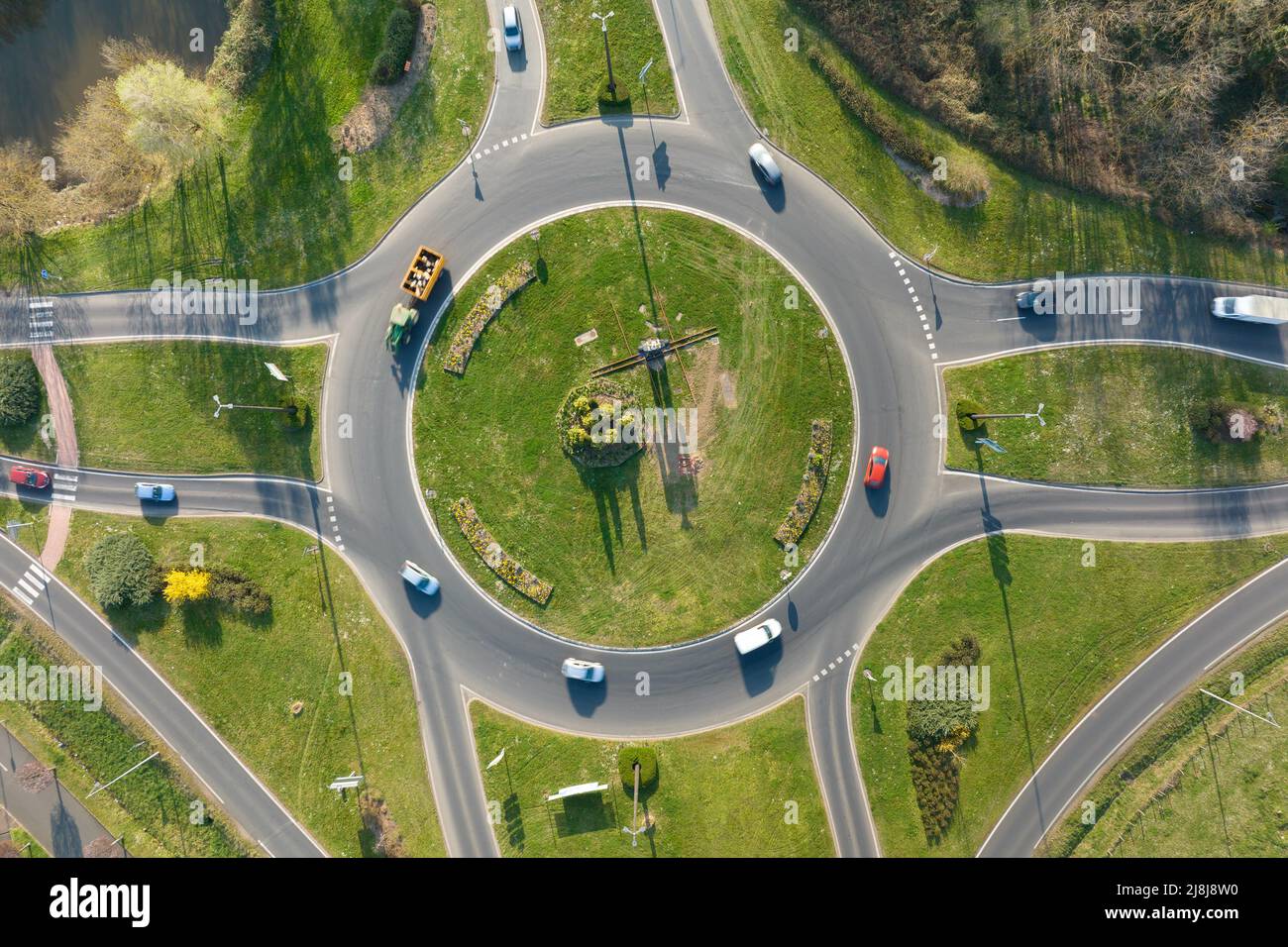 Aerial view of road roundabout intersection with moving heavy traffic ...