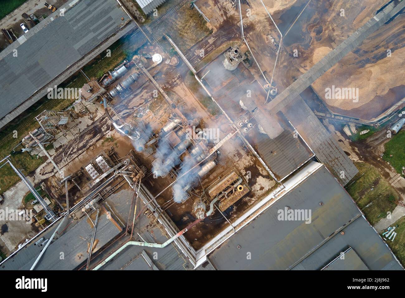 Aerial view of wood processing factory with smoke from production ...