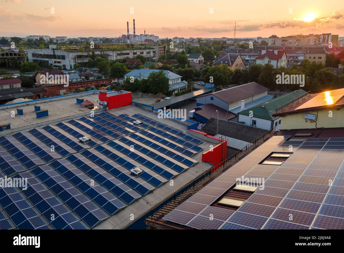Blue photovoltaic solar panels mounted on building roof for producing ...