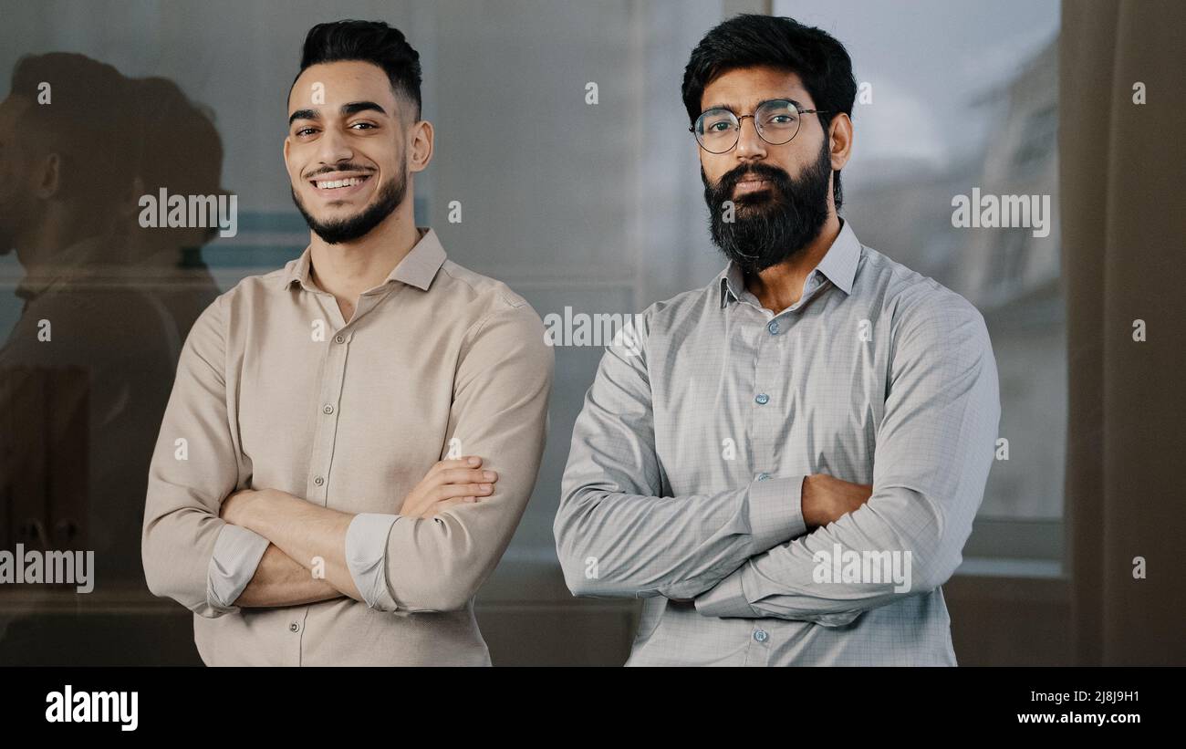 Two happy male colleagues multiracial diverse businesspeople partners ...