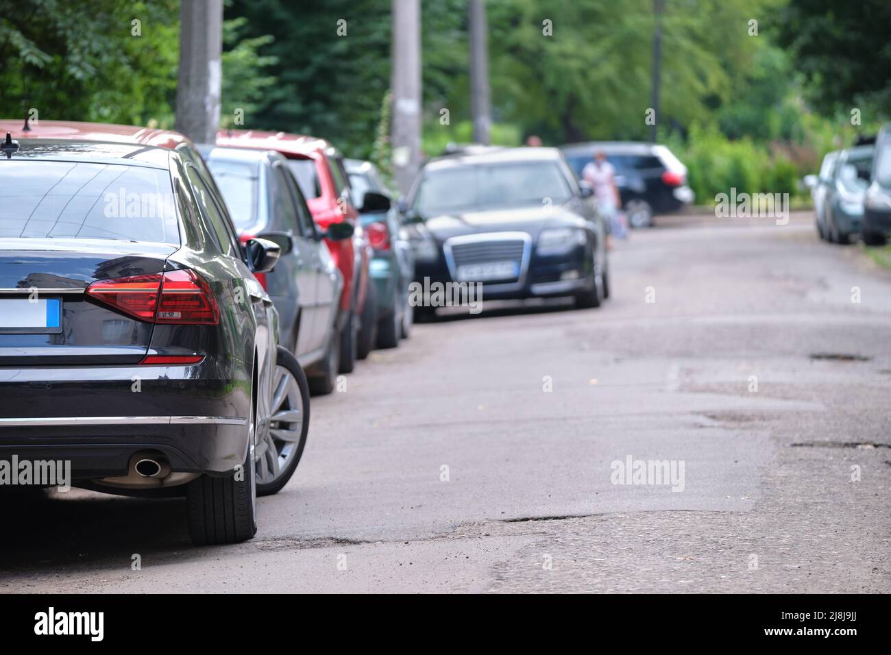 Cars parked in line on city street side. Urban traffic concept Stock ...