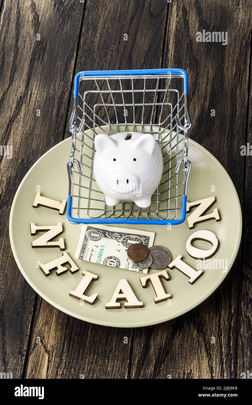 Inflation spelled in letters with american coins and banknotes and ...