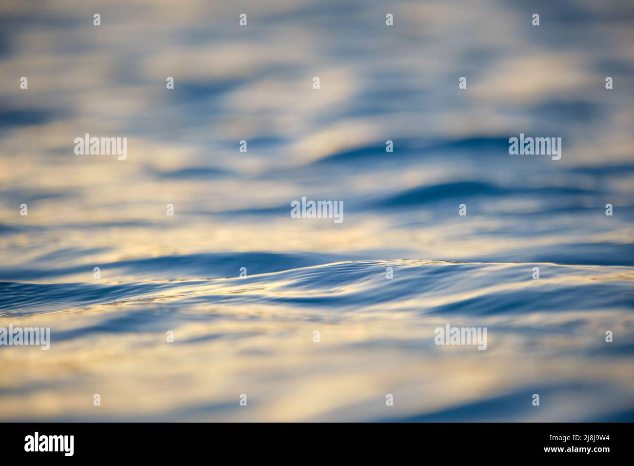 Closeup seascape surface of blue sea water with small ripple waves ...