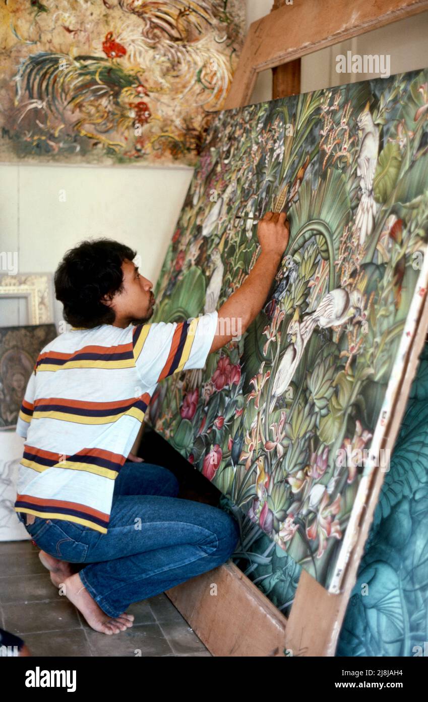 Painter finishing large painting in Agung Rai Studio in Ubud, Bali ...