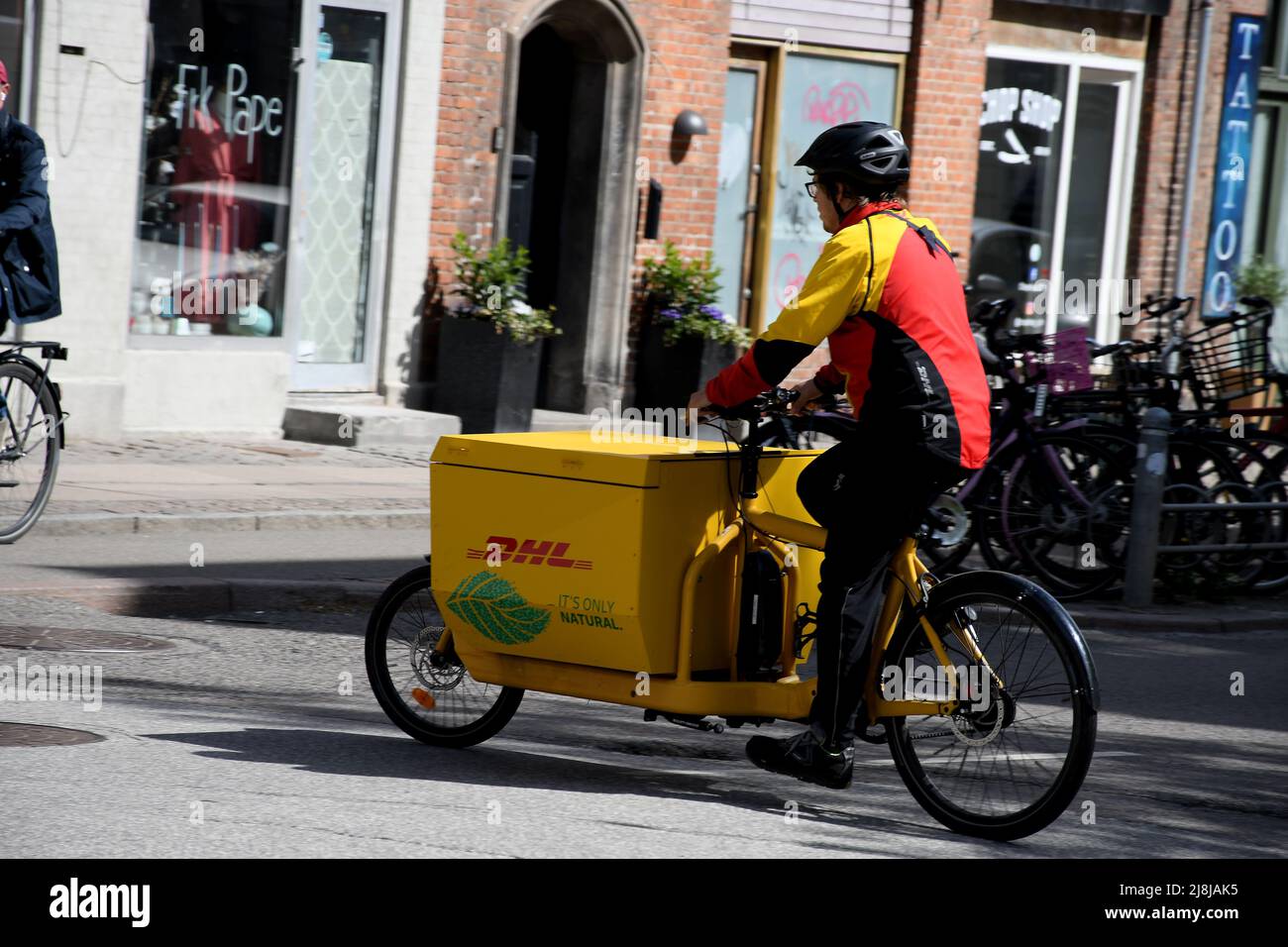 Copenhagen/Denmark/16 May 2022/Deustche DHL bike delivery man in danish ...