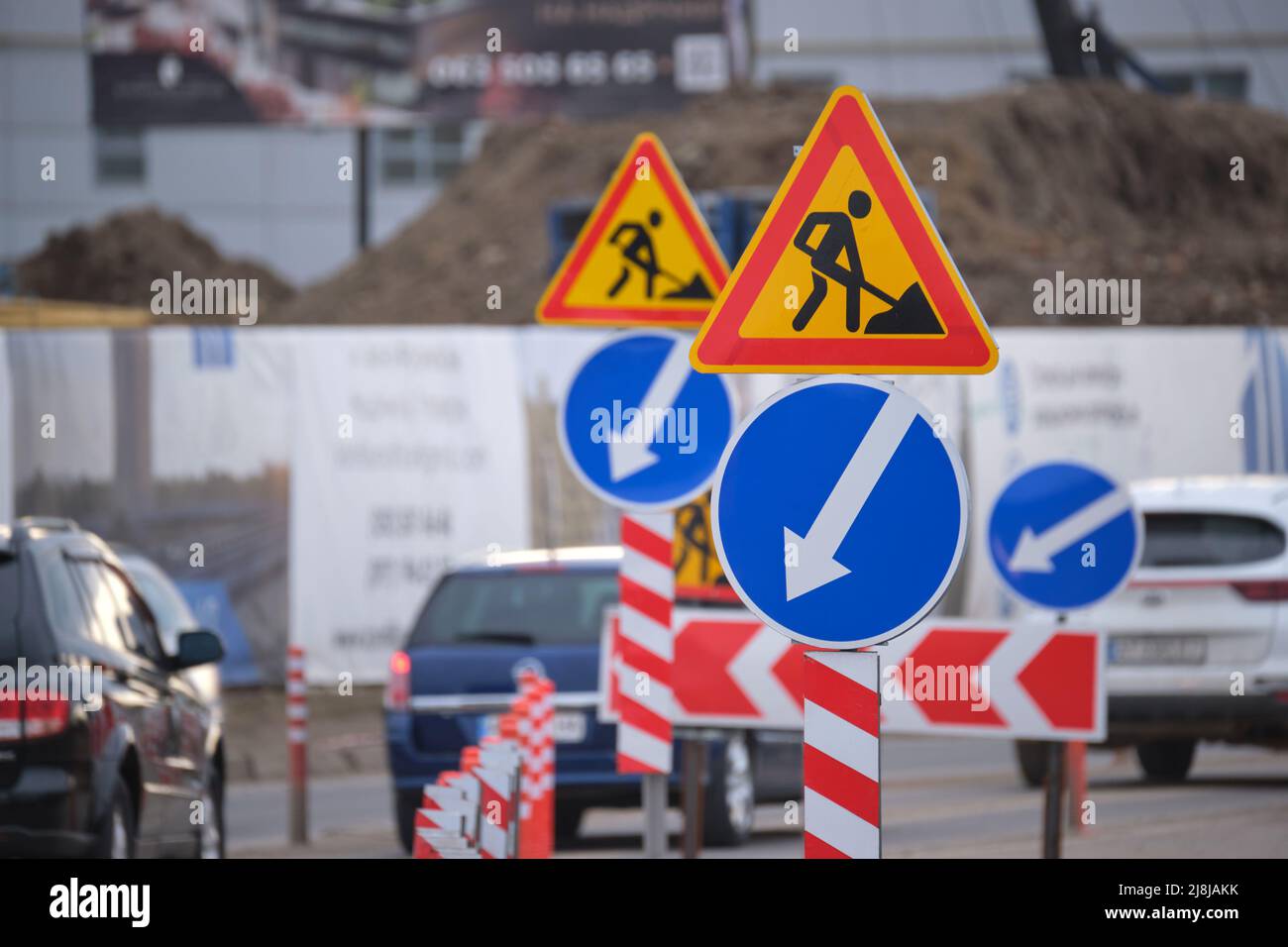 Roadworks warning traffic signs of construction work on city street and ...