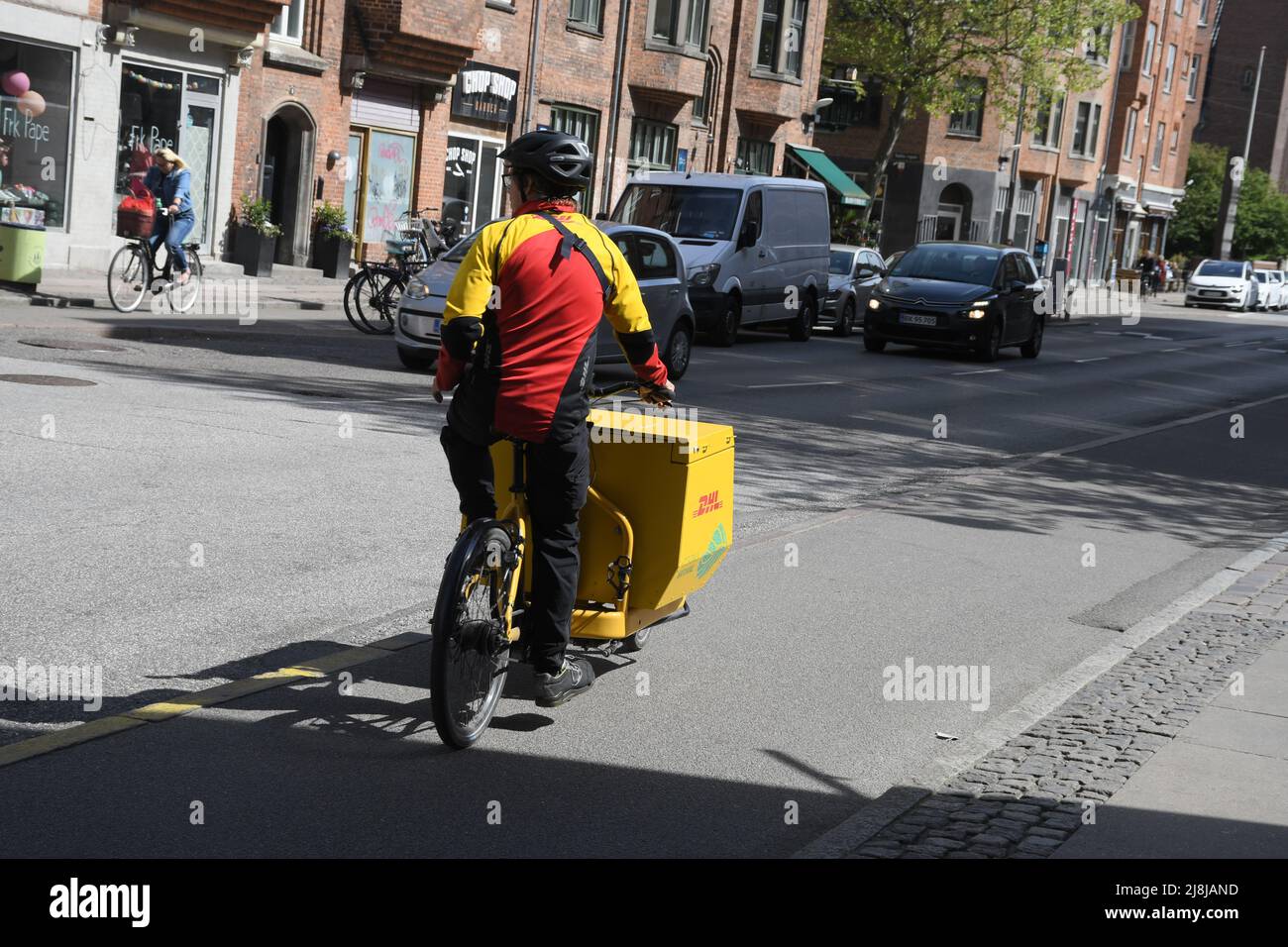 Copenhagen/Denmark/16 May 2022/Deustche DHL bike delivery man in danish ...