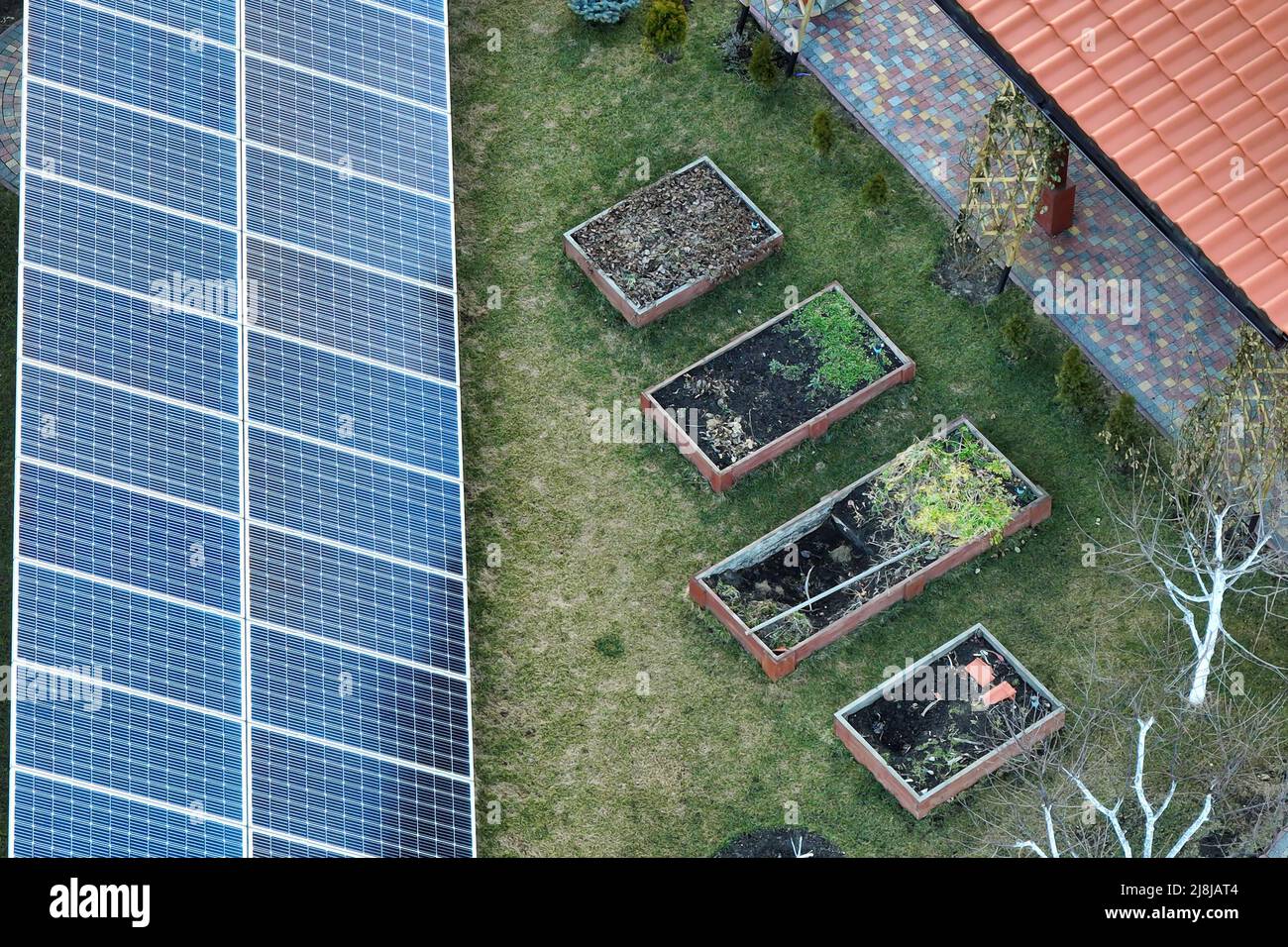 Solar photovoltaic panels mounted on stand-alone frame on backyard ...