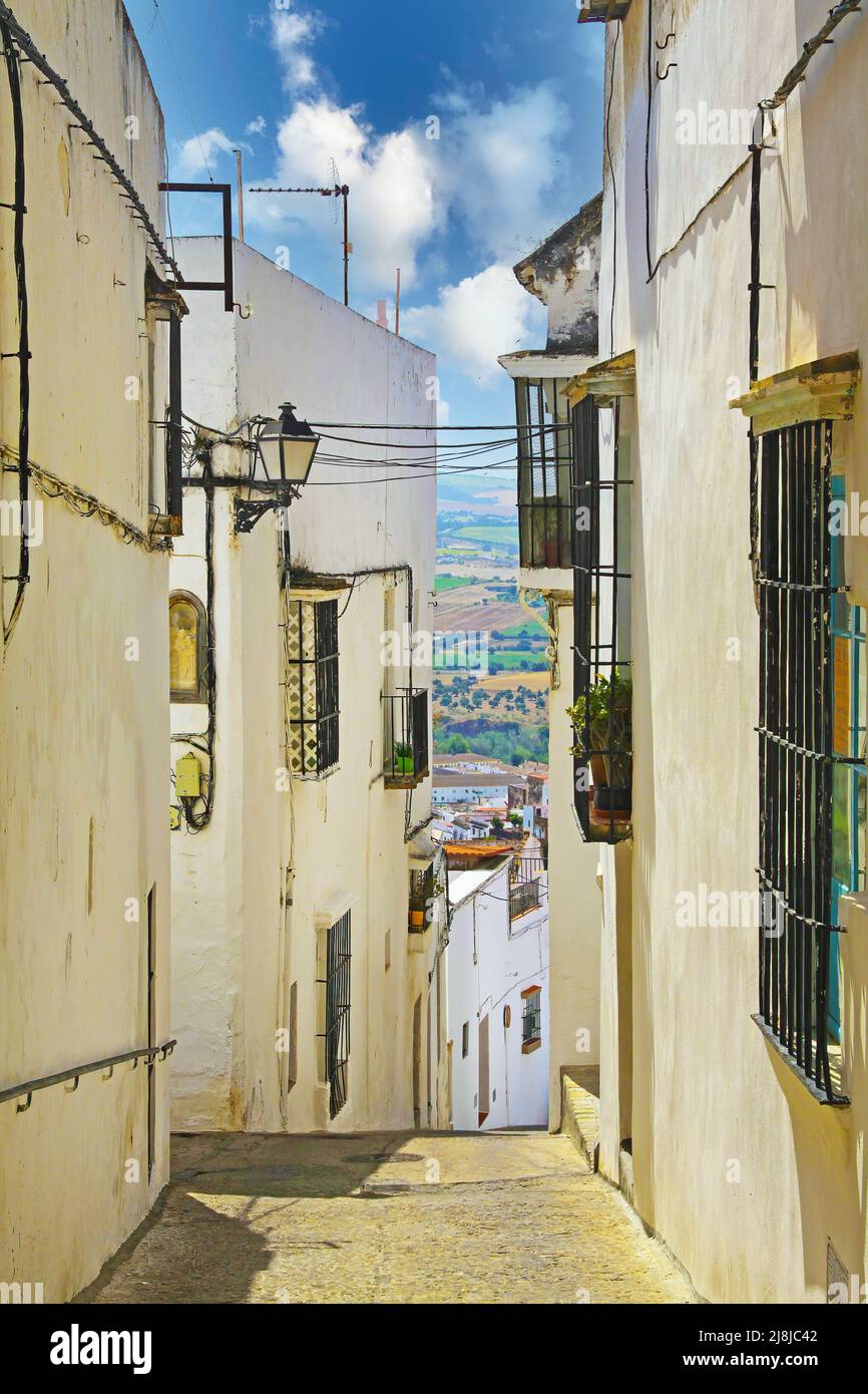Spanish lonely empty alley in rural village, white old houses, blue sky ...