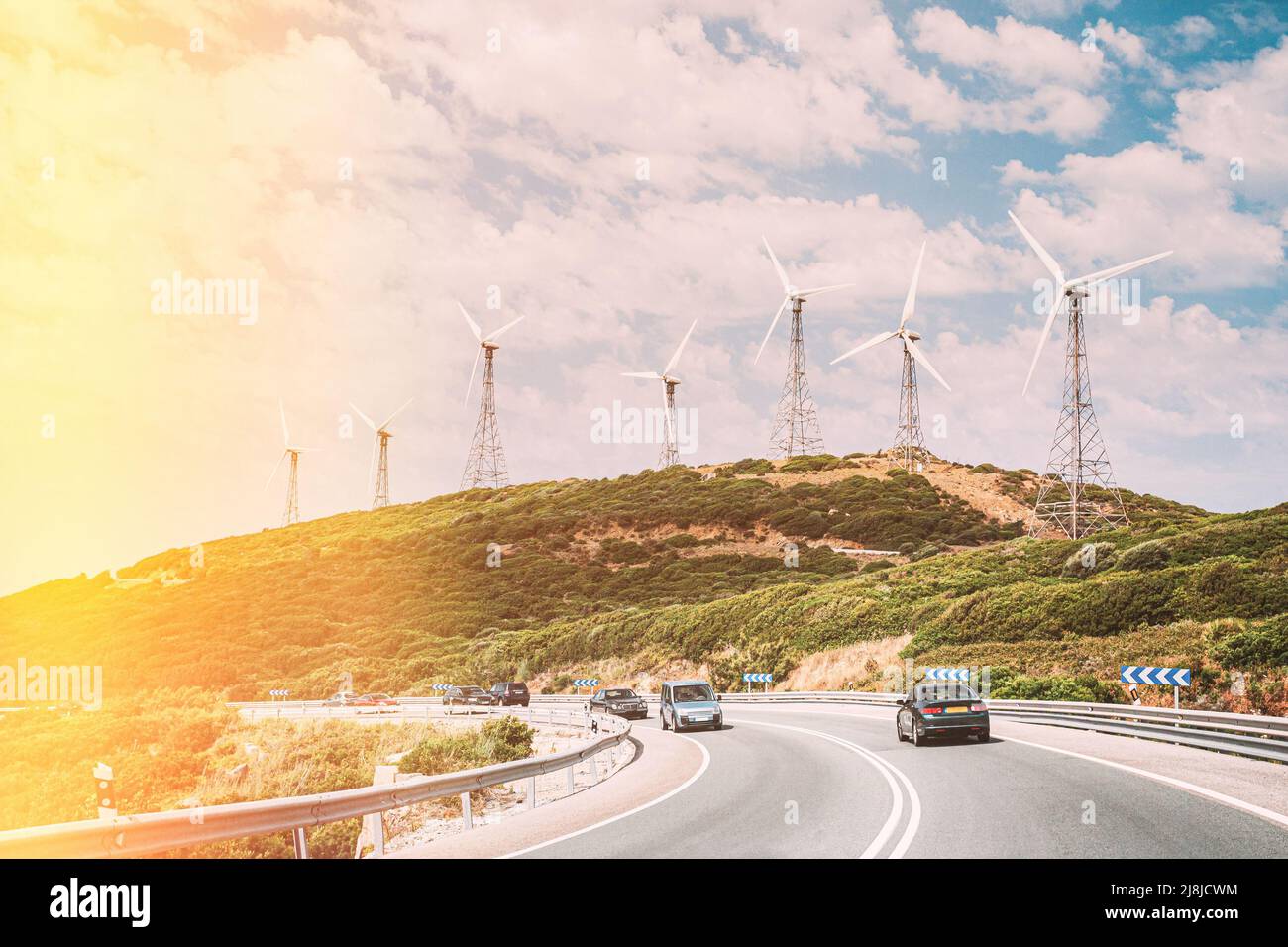 Windmills, wind turbines for electric power production. cars in motion ...