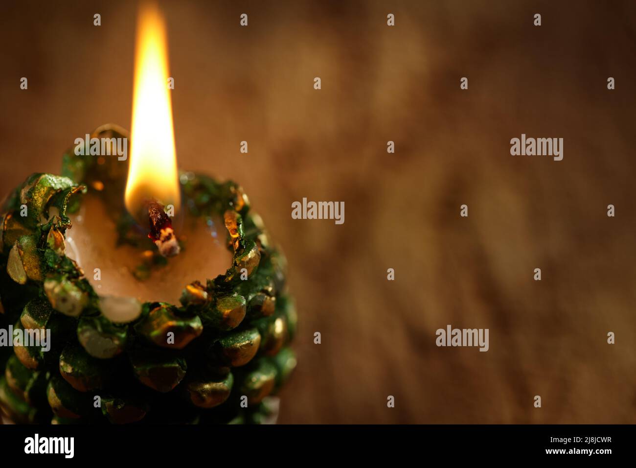 Hot candle in the shape of a Christmas tree. Christmas background with ...