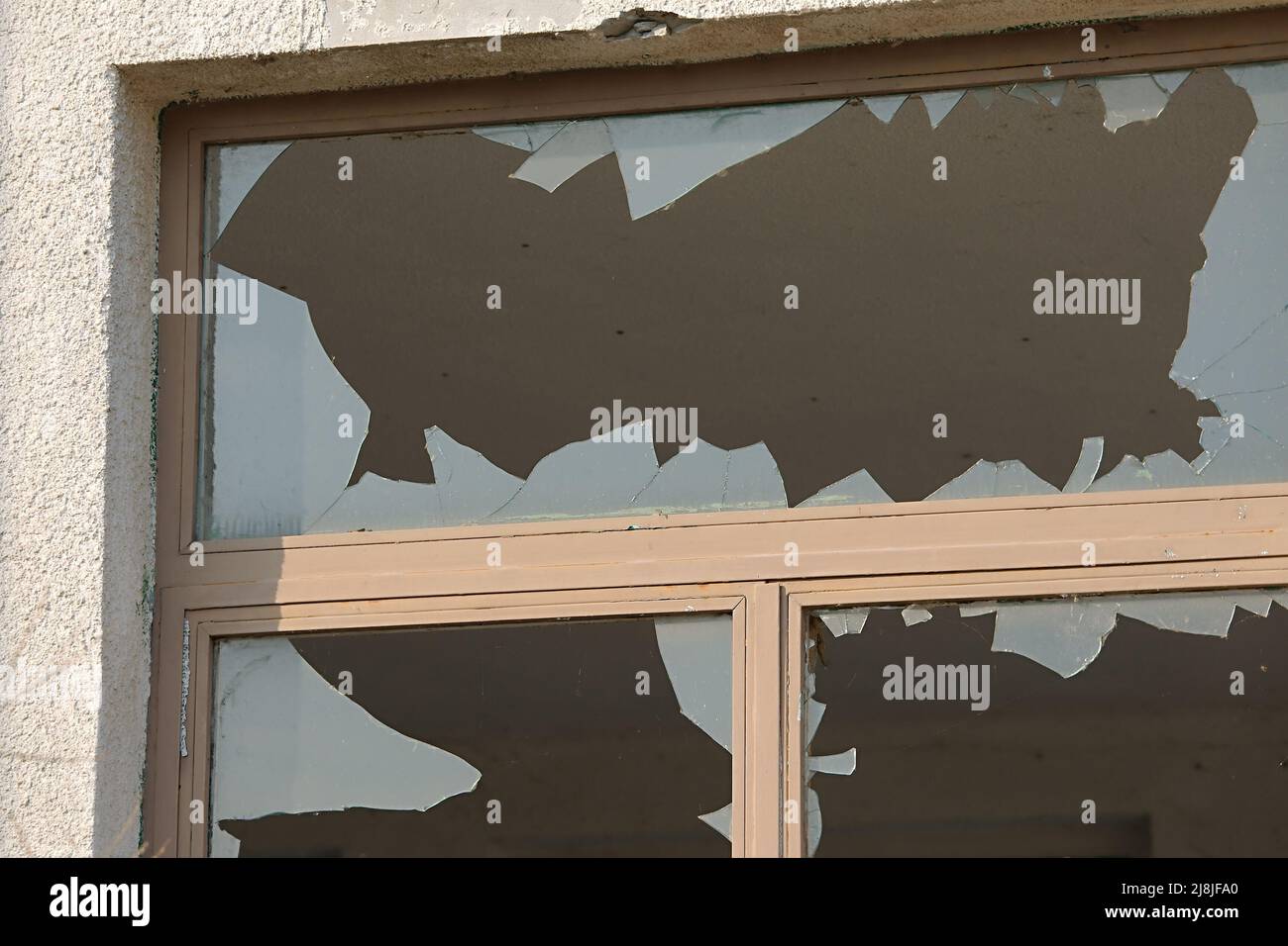 Broken window of abandoned building Stock Photo - Alamy