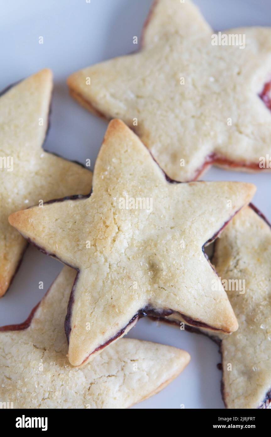 Cookies shaped like stars and filled with red and purple jam, image ...
