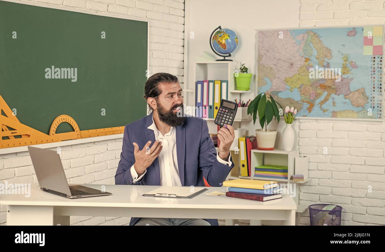 Countless Experience. male student calculating in school classroom ...