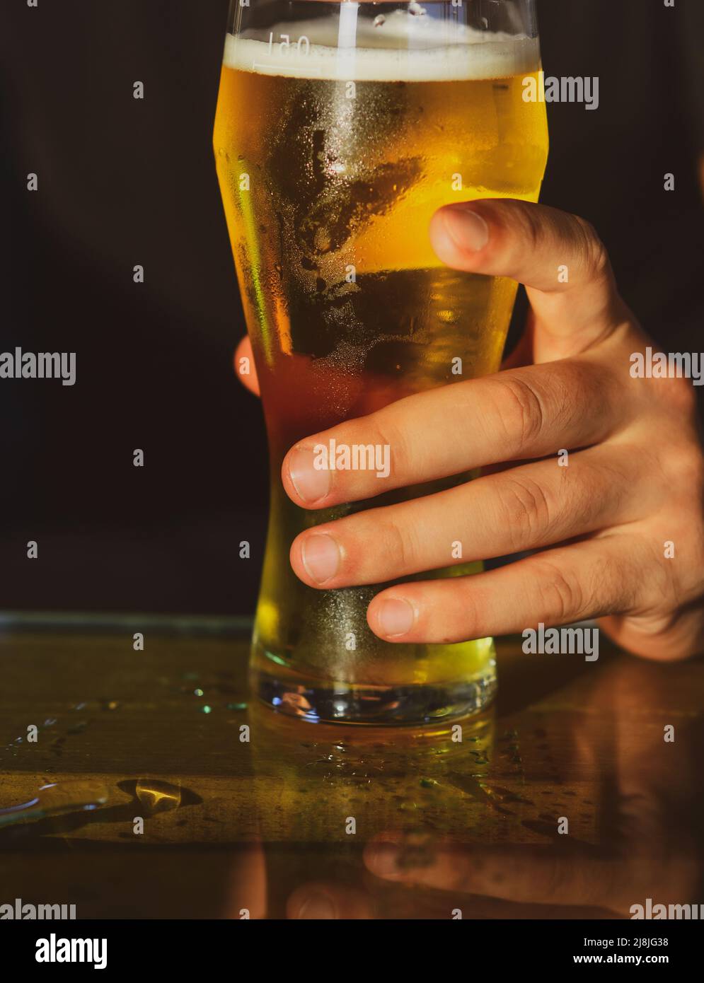 Beer mugs. Man hand hold cup glass of beer Stock Photo - Alamy