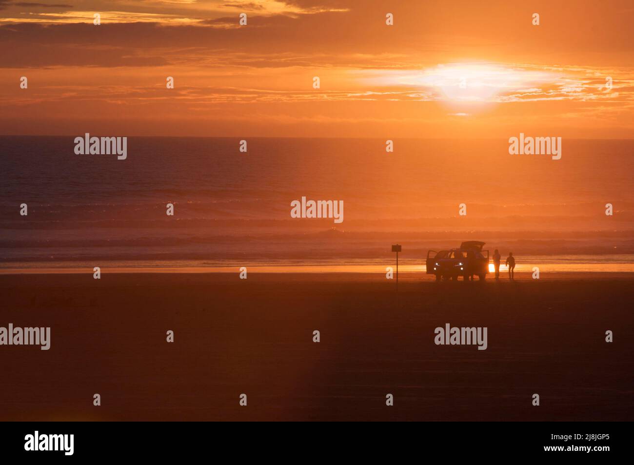 Beach goers with a car enjoying the beautiful sunset at Ocean Shores ...