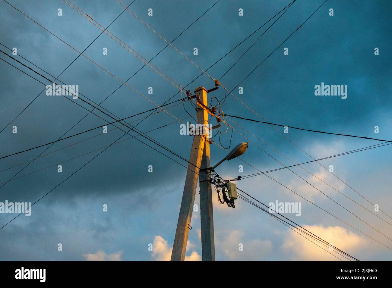 Electrical pole with a lightbulb Stock Photo - Alamy