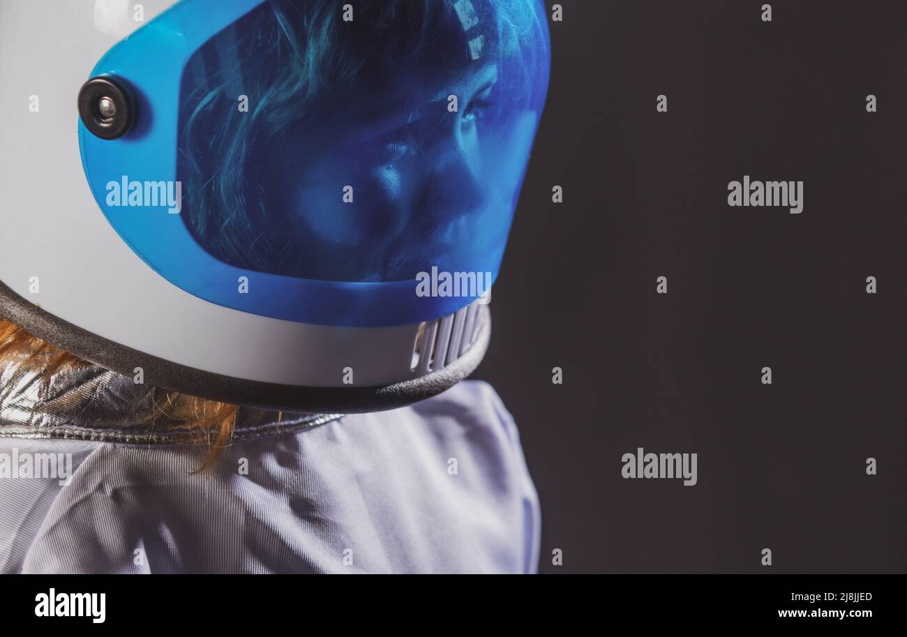 Close up face of child boy imagines himself to be an astronaut in an ...