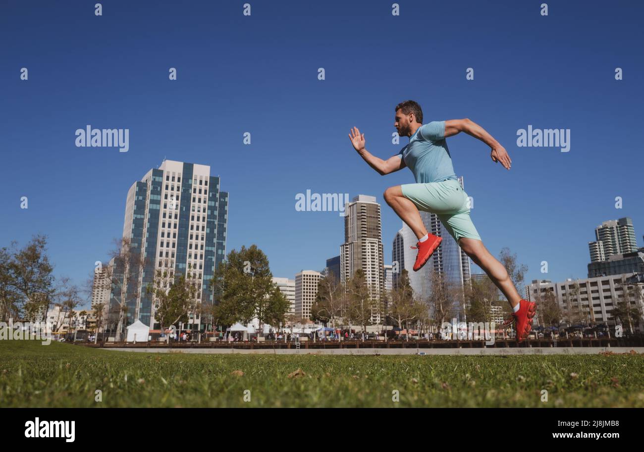 Full length of healthy man running and sprinting outdoors near city ...