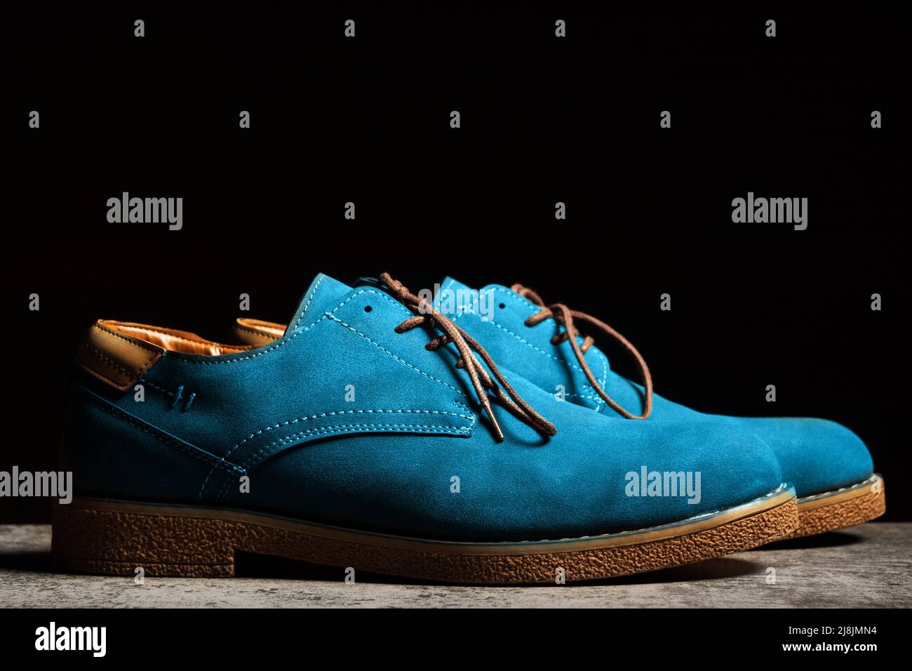 Side view of blue concert shoes with laces on a black background Stock ...