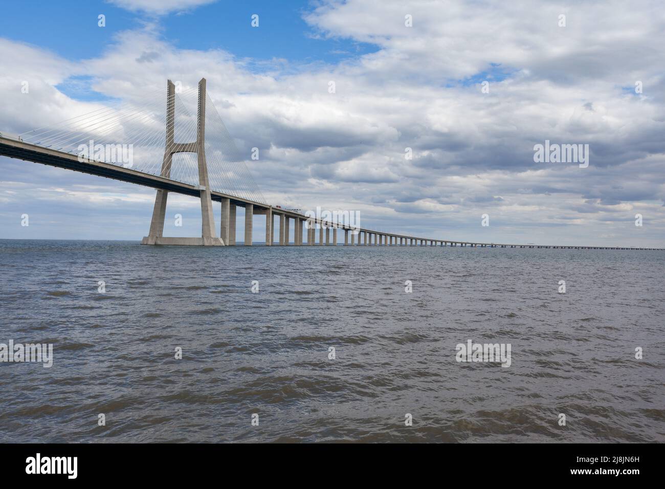 Background with the Lisbon bridge. The Vasco da Gama Bridge is a ...