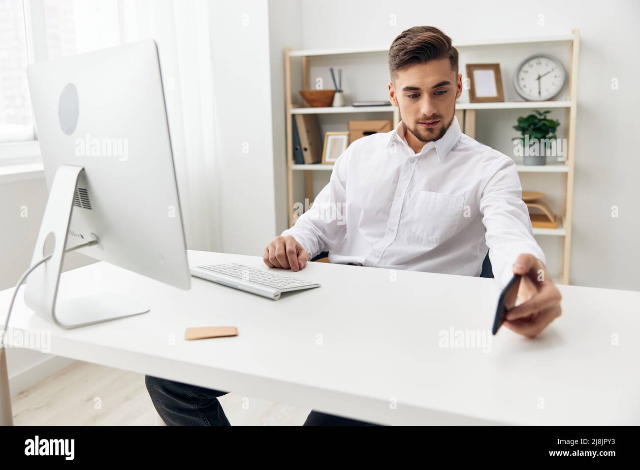 businessmen sitting at a desk in front of a computer with a keyboard ...