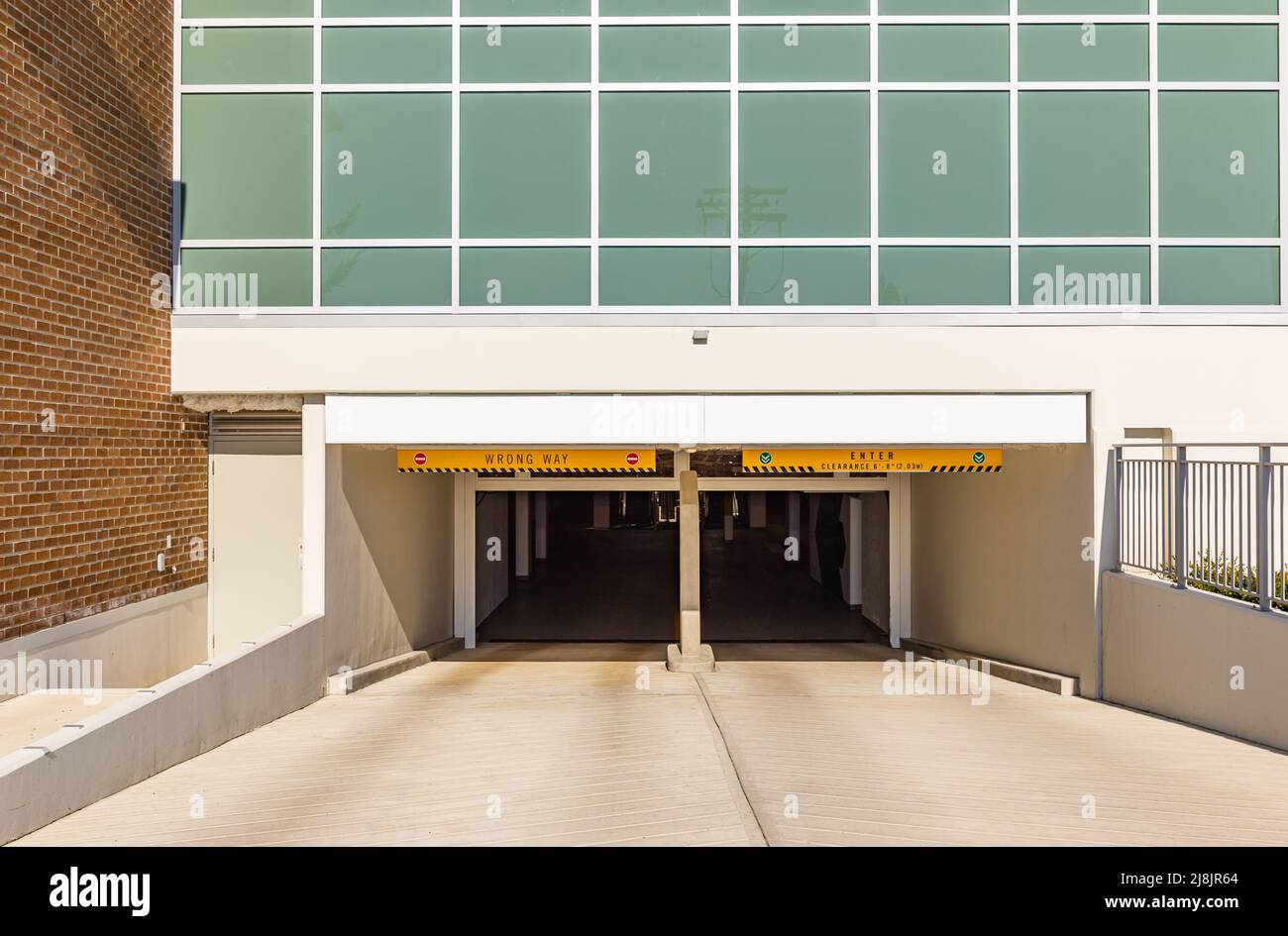 Entrance of underground parking lot in urban central street. Car park ...