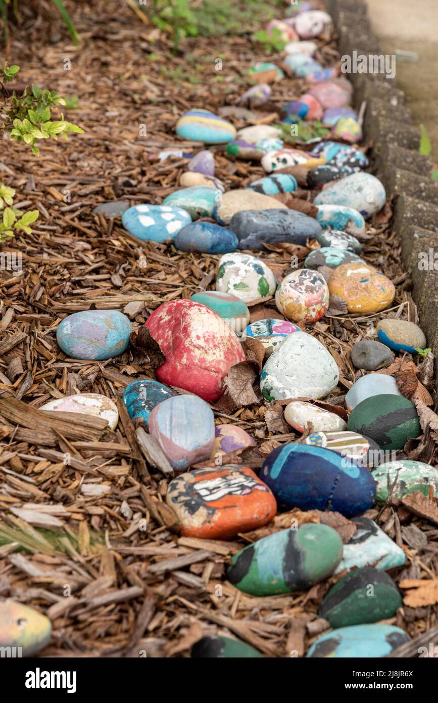 A line of hand-painted rocks on the ground Stock Photo - Alamy