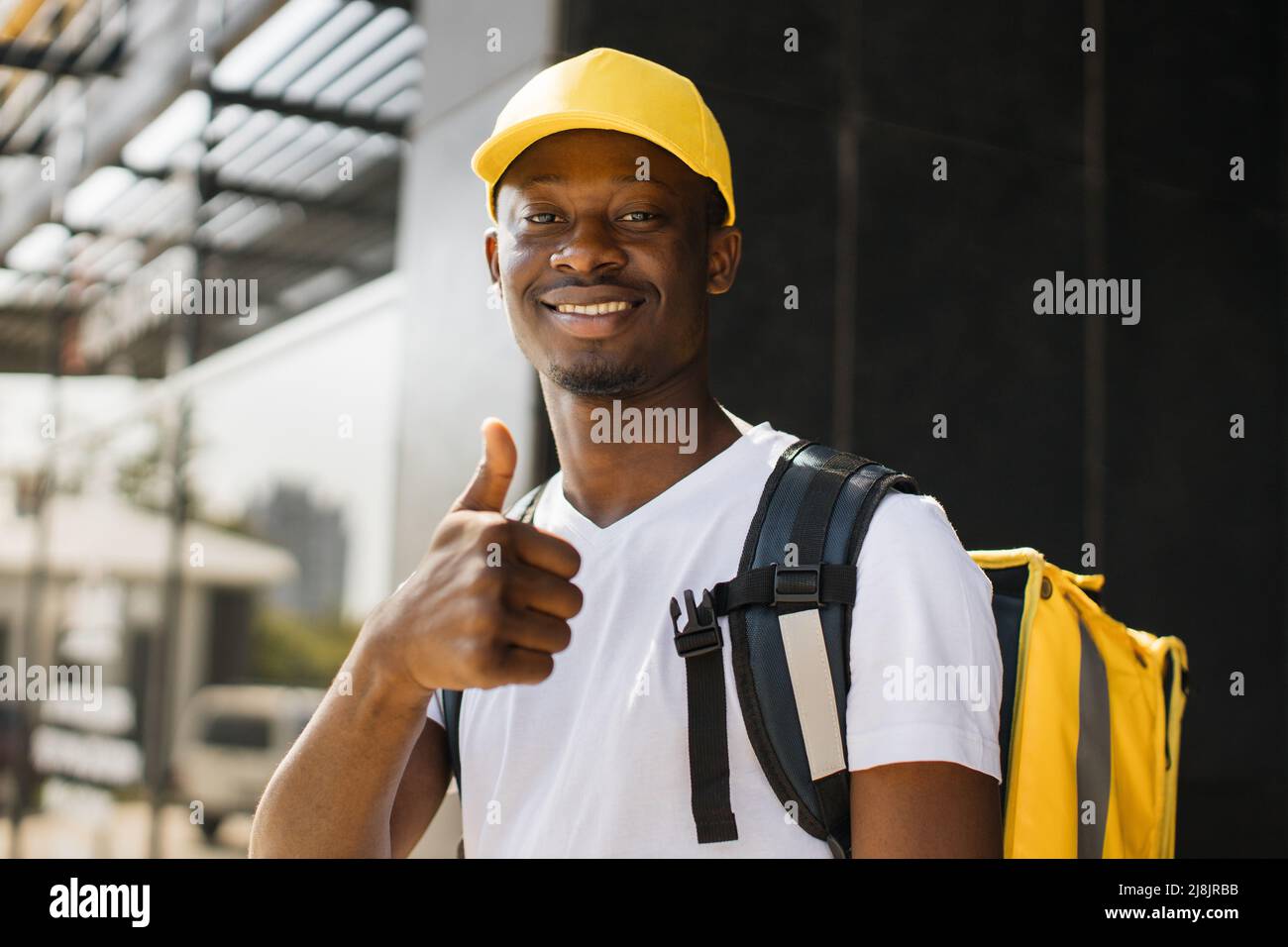 Food delivery, portrait of courier african man with yellow backpack and ...