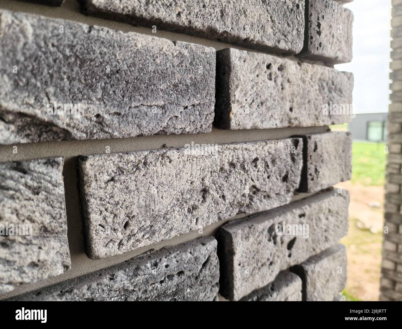 Clinker bricks for house facade decoration during working process Stock Photo - Alamy