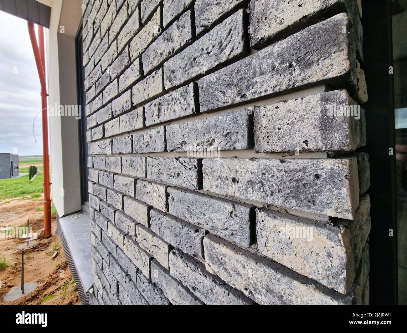 Clinker bricks for house facade decoration during working process Stock ...