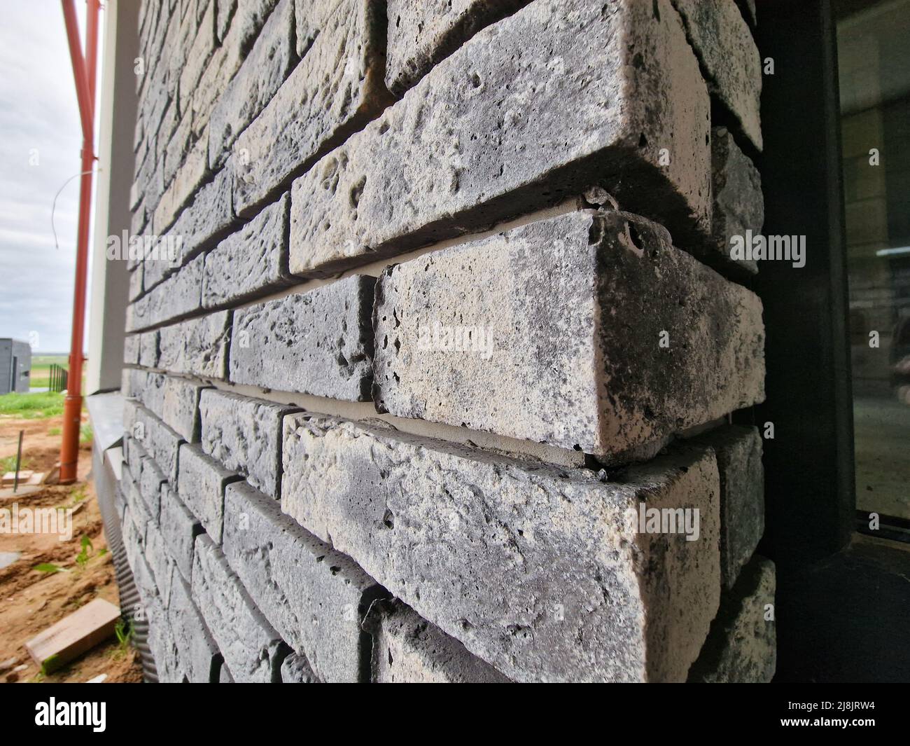 Clinker bricks for house facade decoration during working process Stock ...