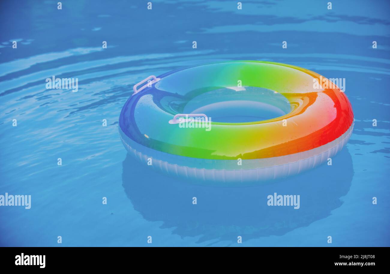 Pool float, ring floating in a refreshing blue swimming pool. Summer ...
