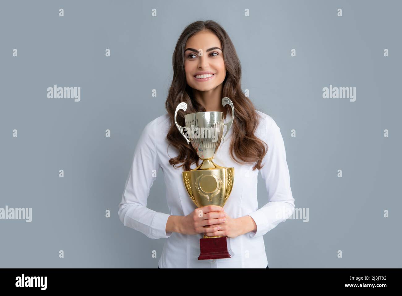 Winning businesswoman holding a trophy. Business woman with prize ...