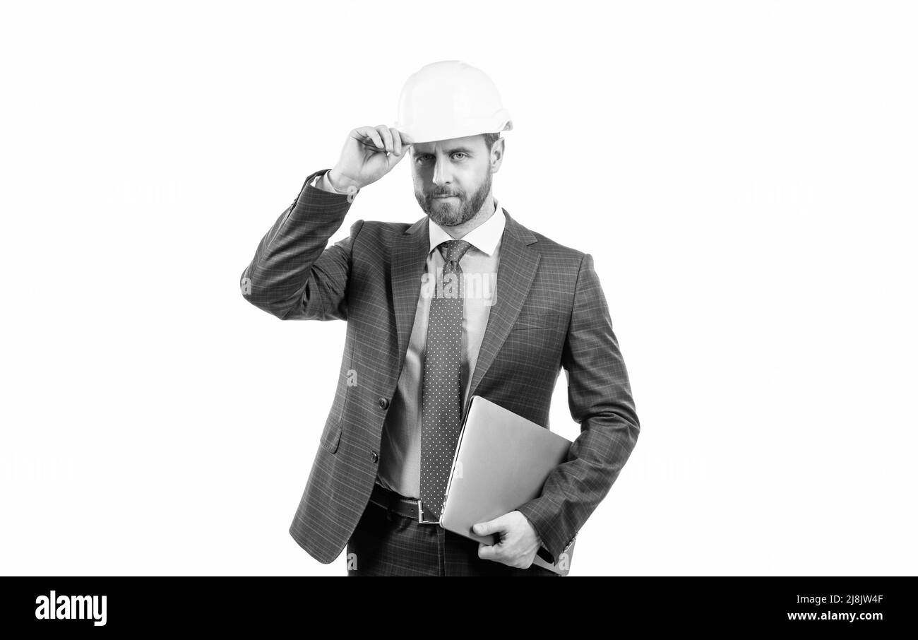 architect working on project. chief engineer in hardhat hold computer ...