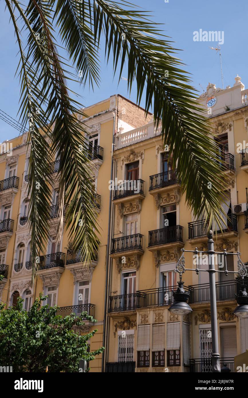 View of apartment buildings and palm trees on Gran Via ward, Eixample ...