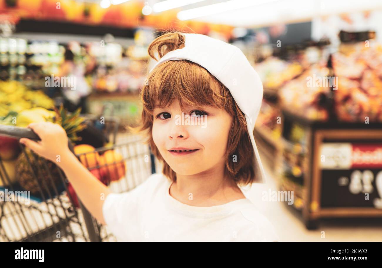 Kid in supermarket shop. Toddler boy with shopping bag in store Stock Photo - Alamy