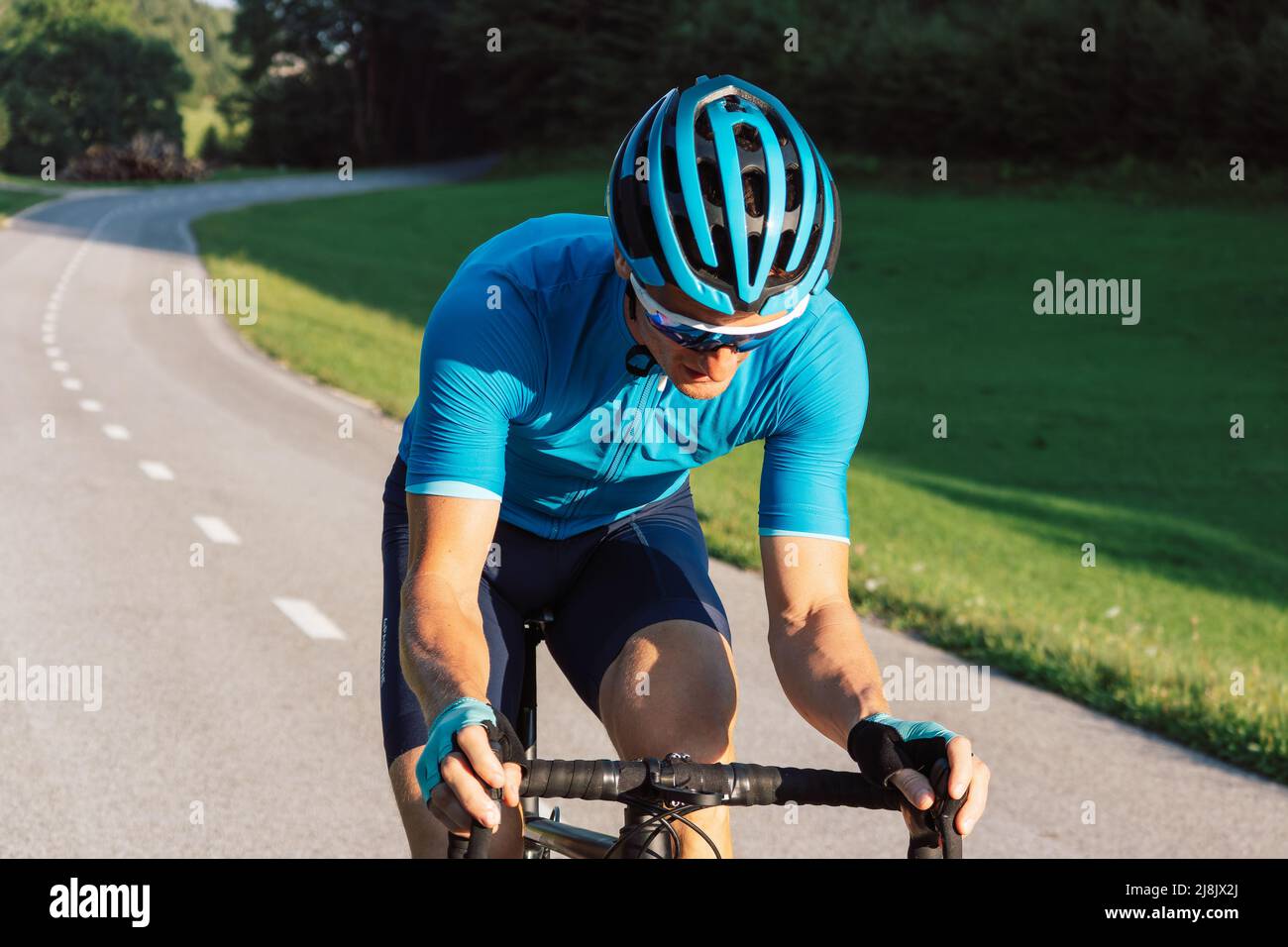 Muscular man, professional racing bicyclist sprint cycling, with ...