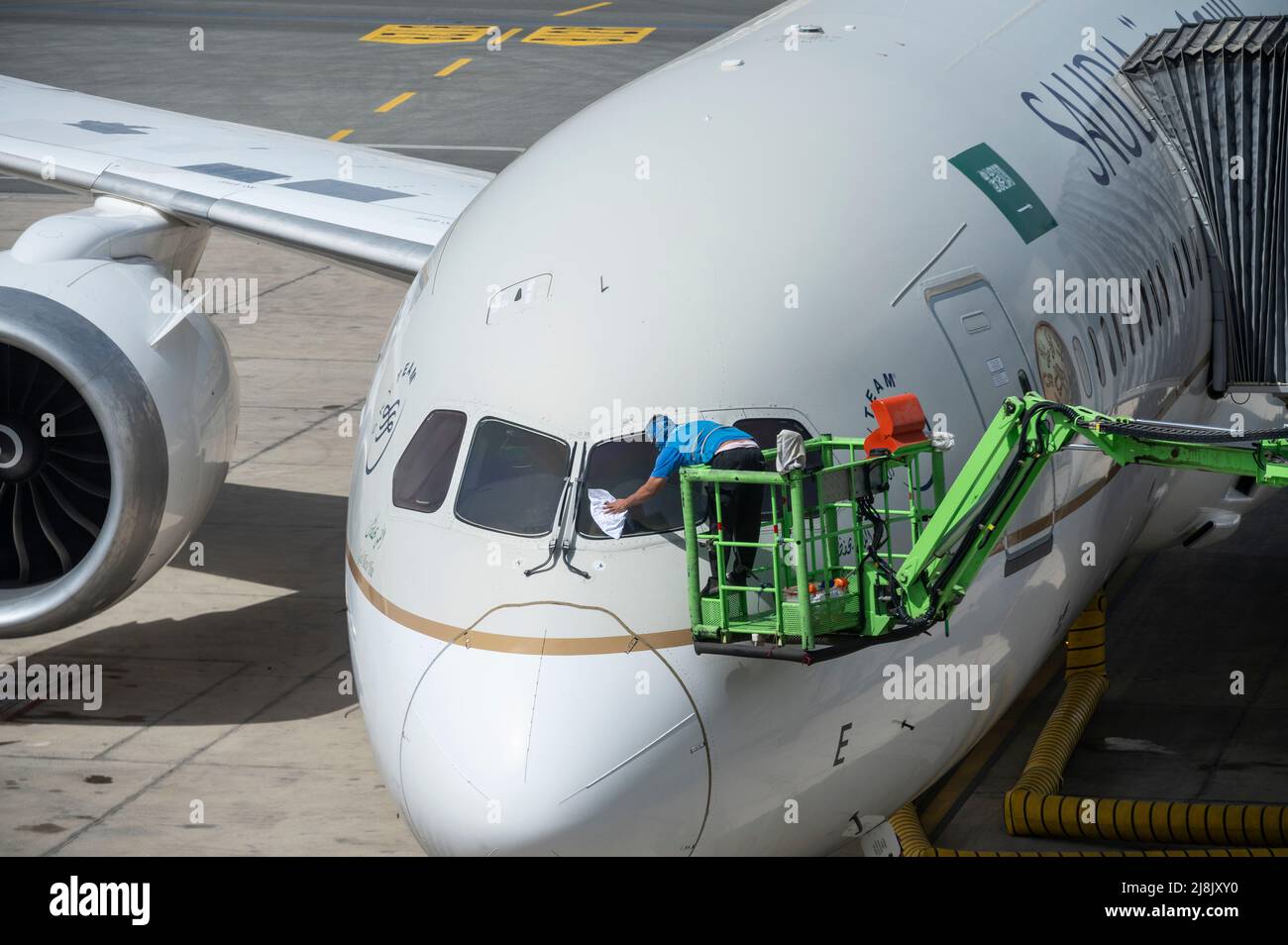 A worker cleans the front window of a flag carrier Saudi Arabia, Saudi ...