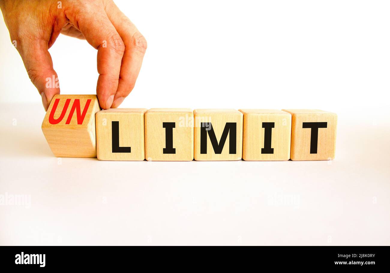 Limit or unlimit symbol. Businessman turns wooden cubes and changes the ...