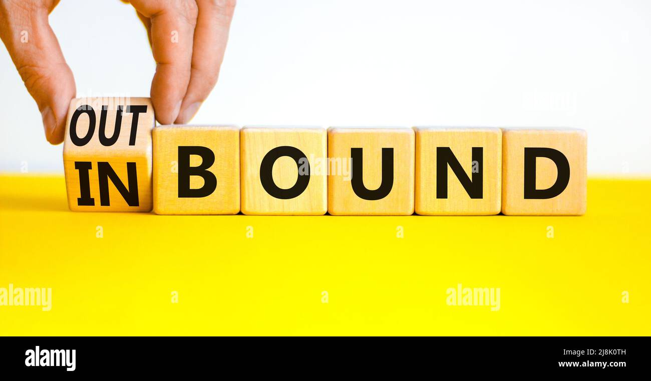 Inbound or outbound symbol. Businessman turns wooden cubes and changes ...