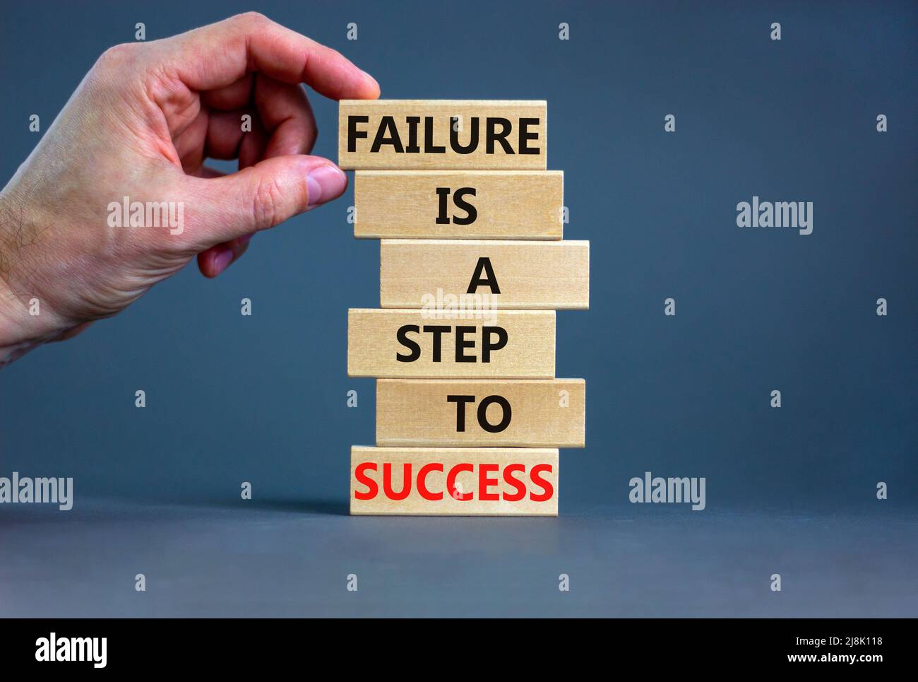 Failure or success symbol. Wooden blocks with words A failure is a step ...