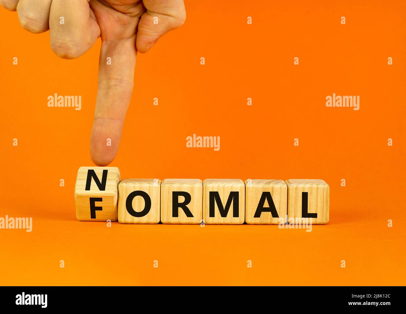 Formal or normal symbol. Businessman turns wooden cubes and changes the ...