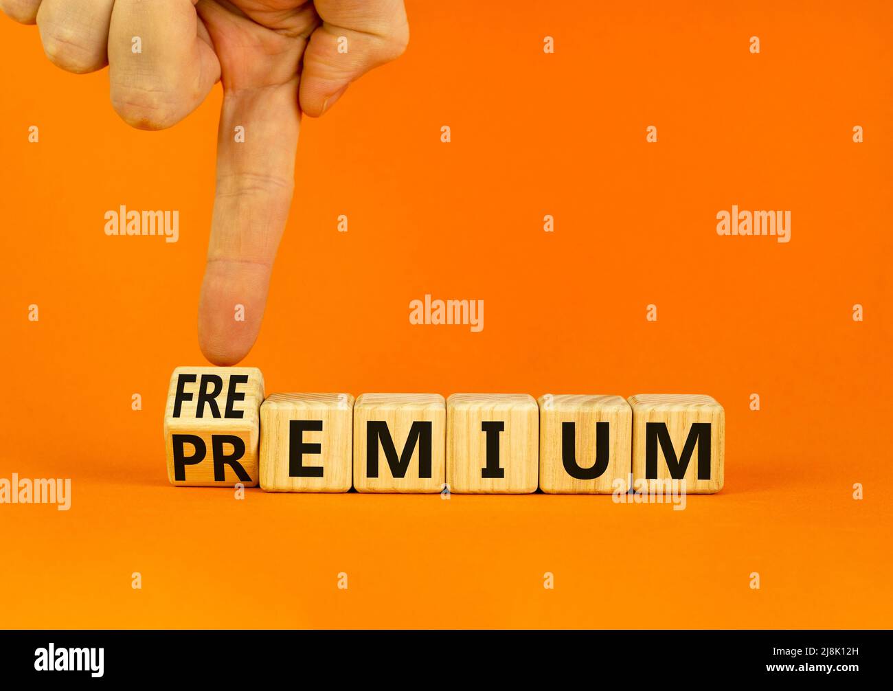 Premium or freemium symbol. Businessman turns wooden cubes and changes ...